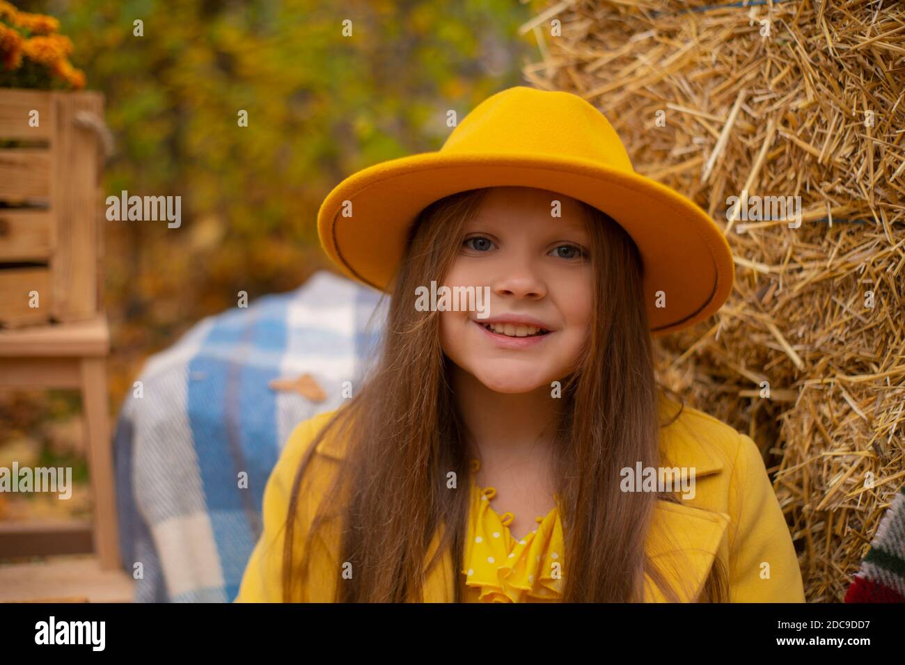 portrait of cute beautiful teenage brunette girl in an orange hat ...