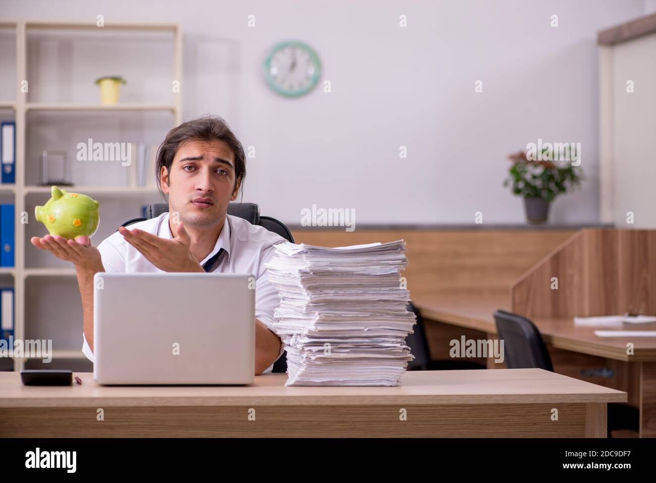 Young employee in remuneration concept Stock Photo - Alamy