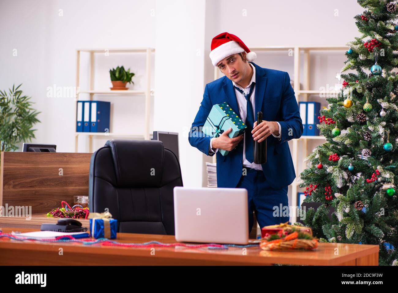 Employee in office during christmas party Stock Photo - Alamy