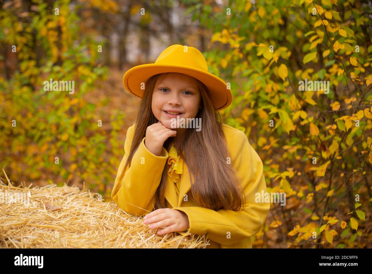 portrait of cute beautiful teenage brunette girl in an orange hat ...