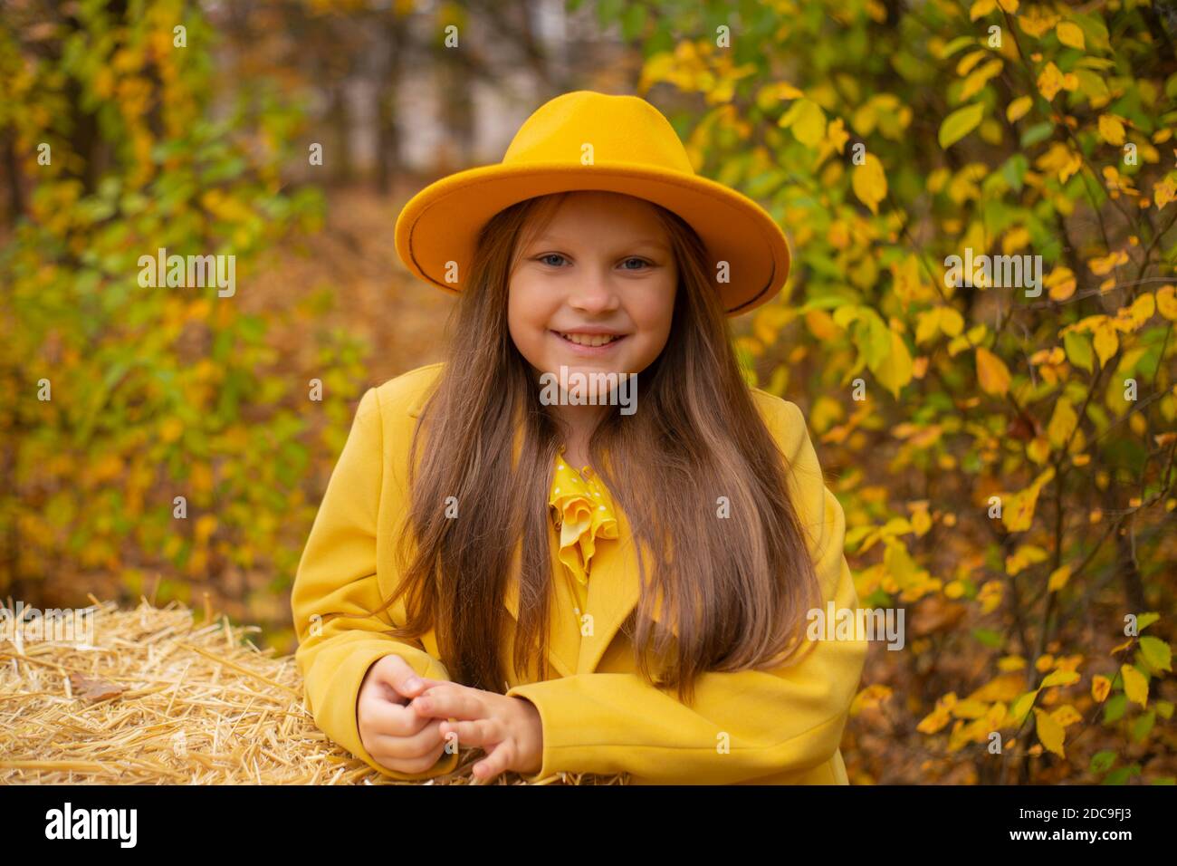 portrait of cute beautiful teenage brunette girl in an orange hat ...