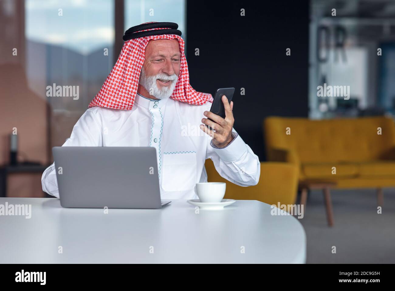 Arab businessman laptop computer in modern office using phone Stock ...