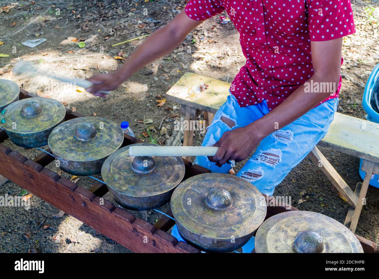 An indigenous muslim woman playing on a set of kulintang or asian gongs in Cotabato City ...