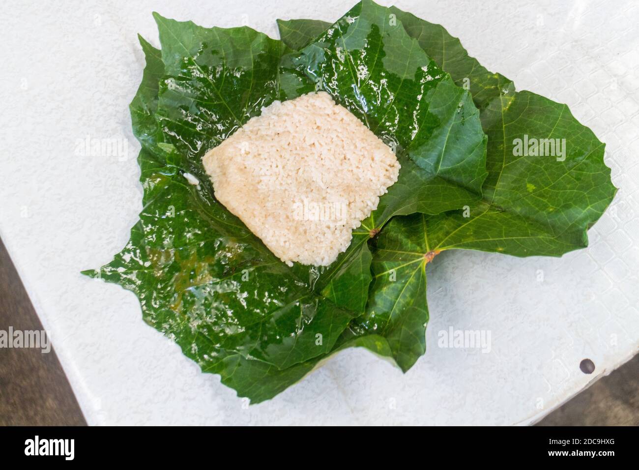 A serving of tapai, a local dish of fermented rice wrapped in leaves, a ...