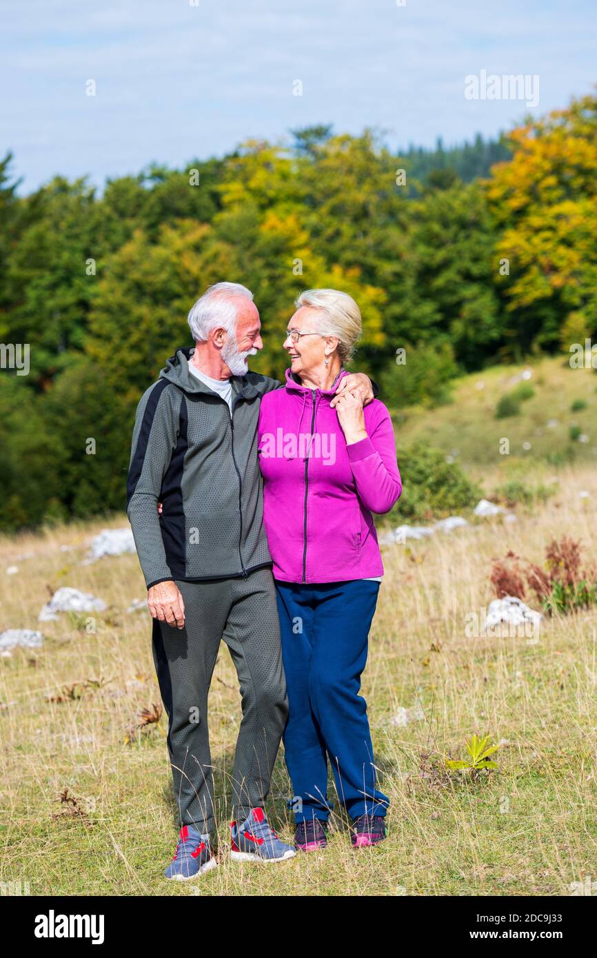 Senior couple walking in a beautiful nature Stock Photo - Alamy