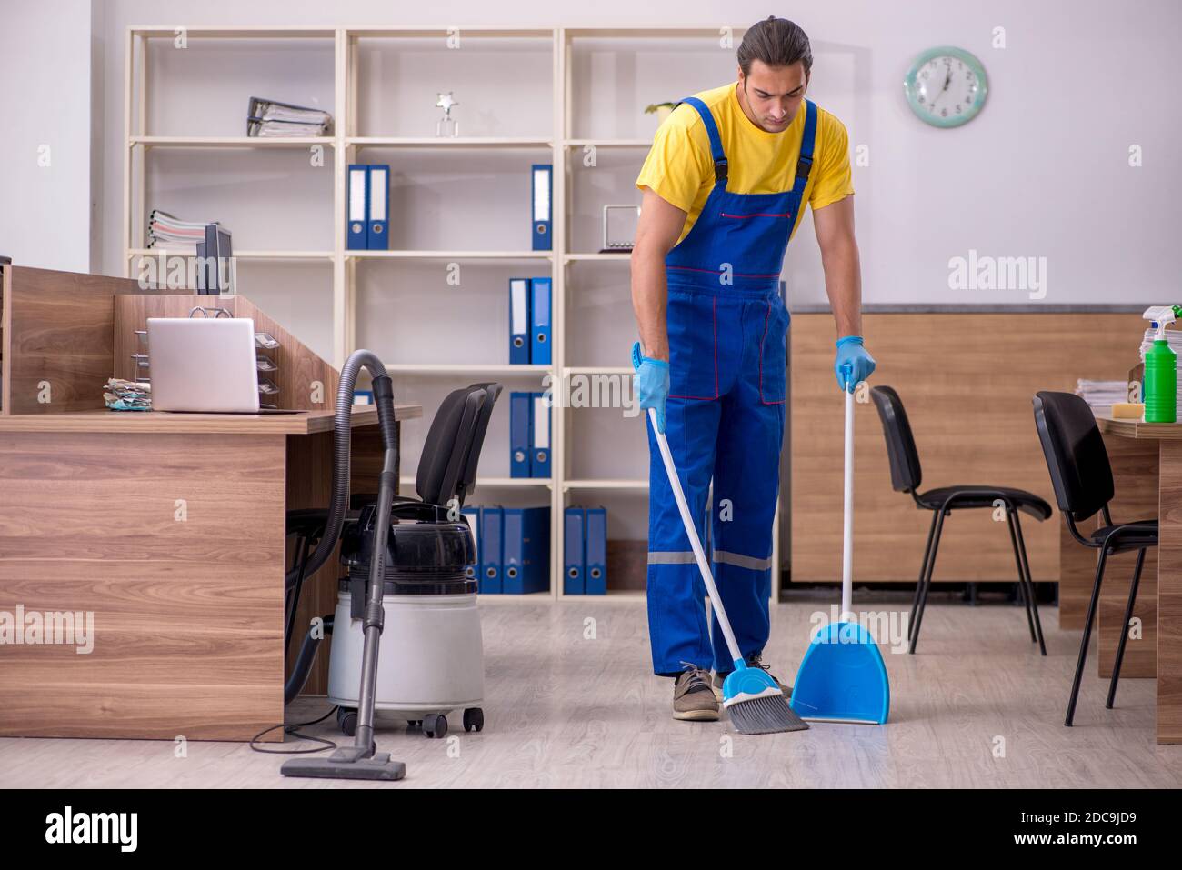 Male contractor cleaning the office Stock Photo - Alamy