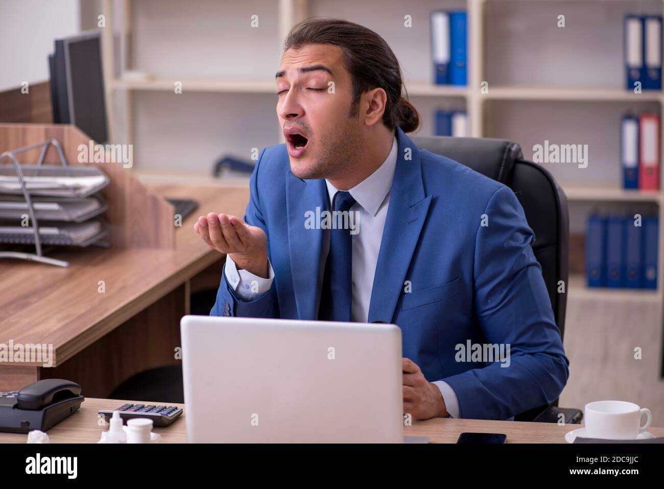 Sick businessman employee suffering at workplace Stock Photo - Alamy