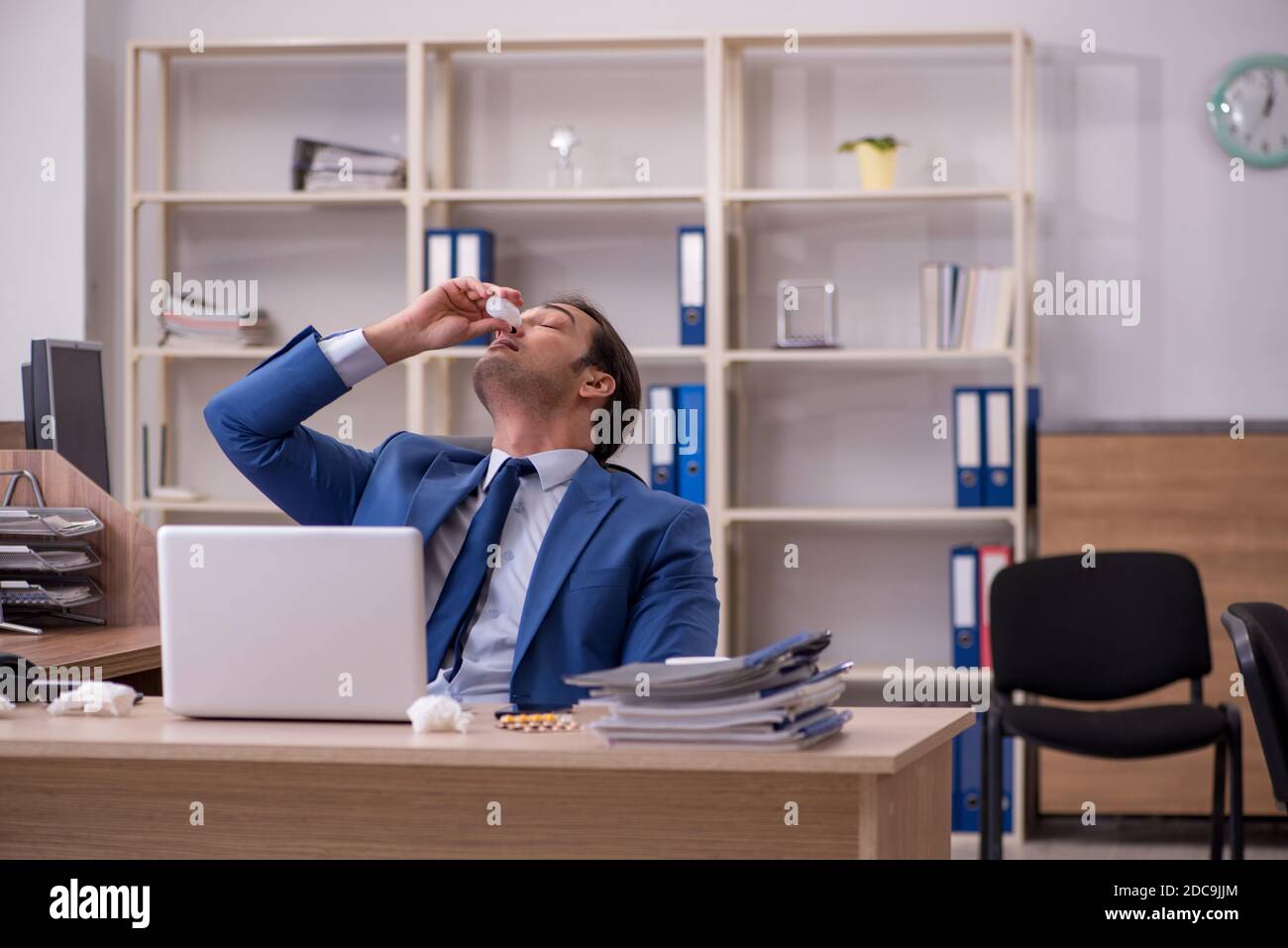 Sick businessman employee suffering at workplace Stock Photo - Alamy