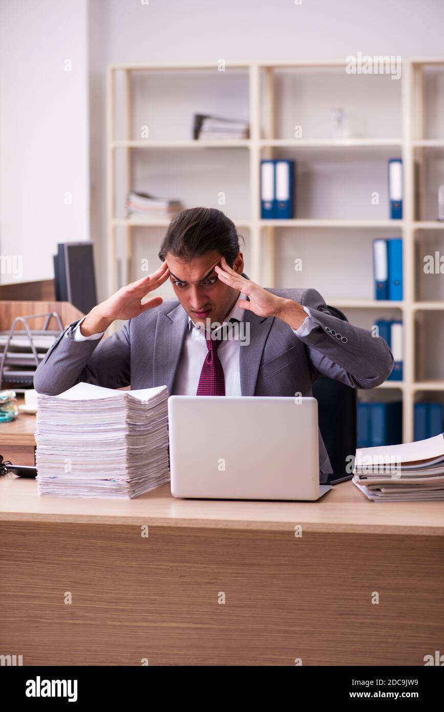 Young employee extremely tired with excessive work Stock Photo - Alamy