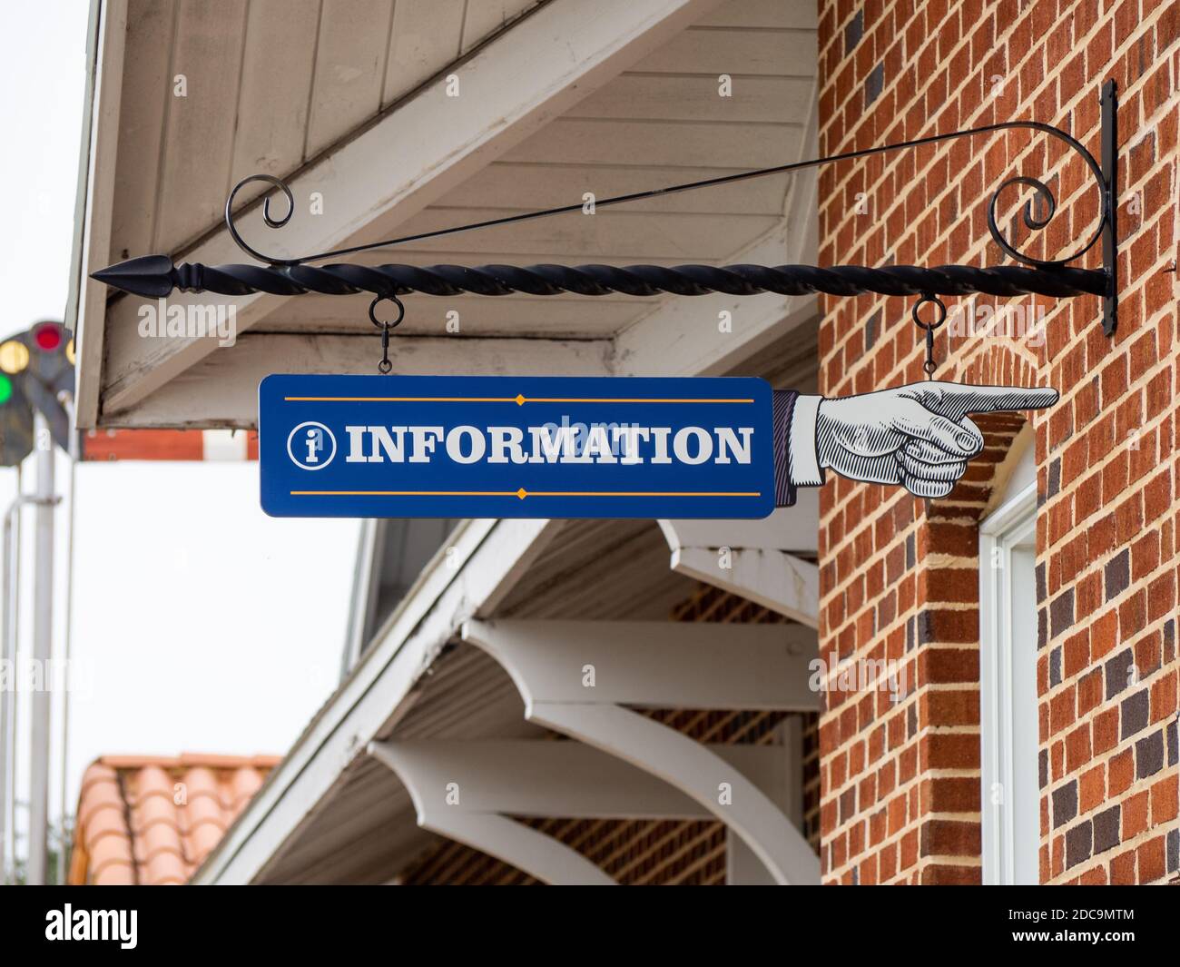 Hanging information sign pointing inside Stock Photo - Alamy