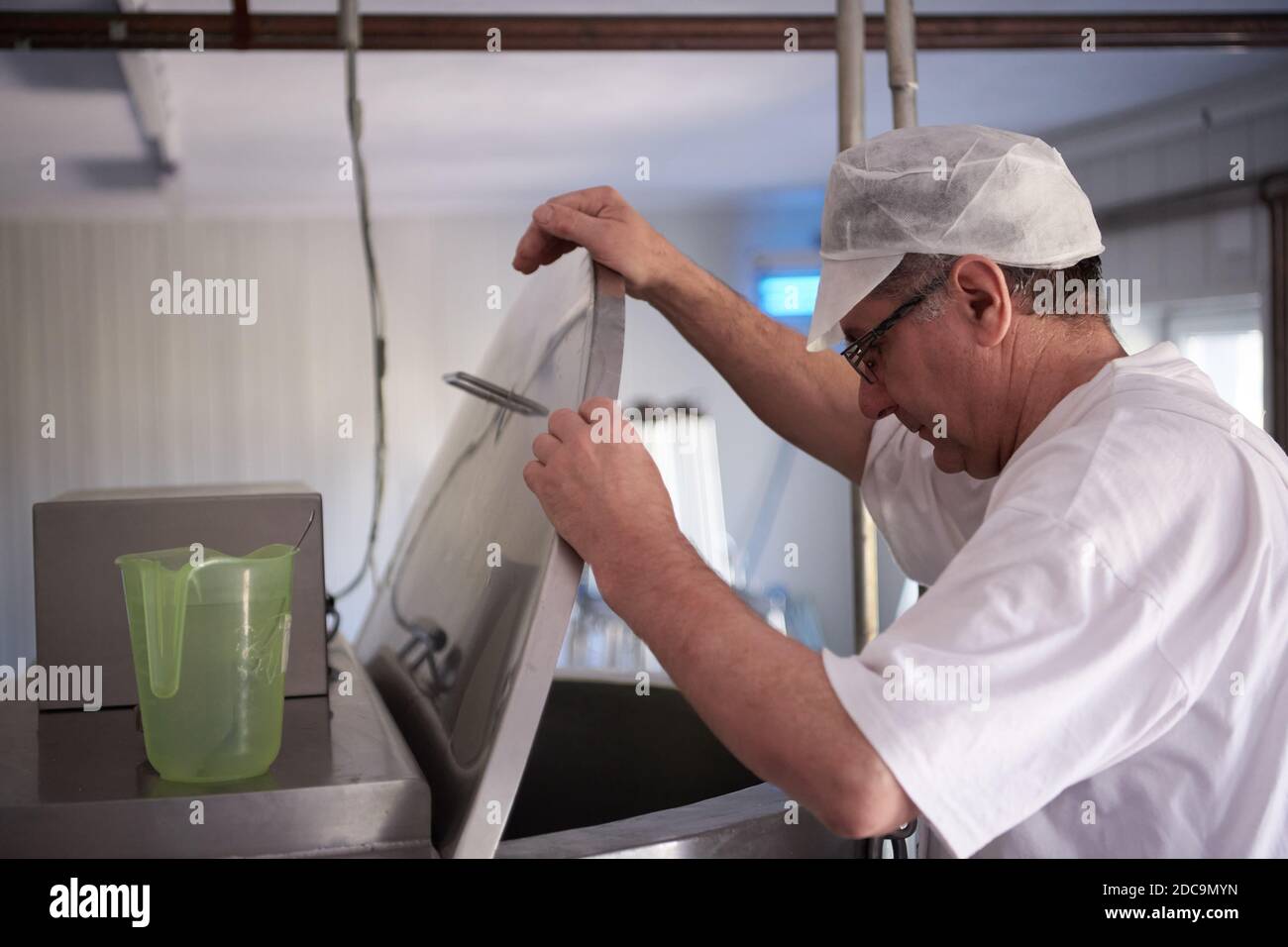 Manual worker cheesemaker in hi-res stock photography and images - Alamy