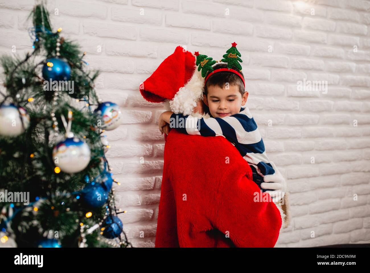 A cute boy with a prop on his head in the arms of a man dressed in a ...