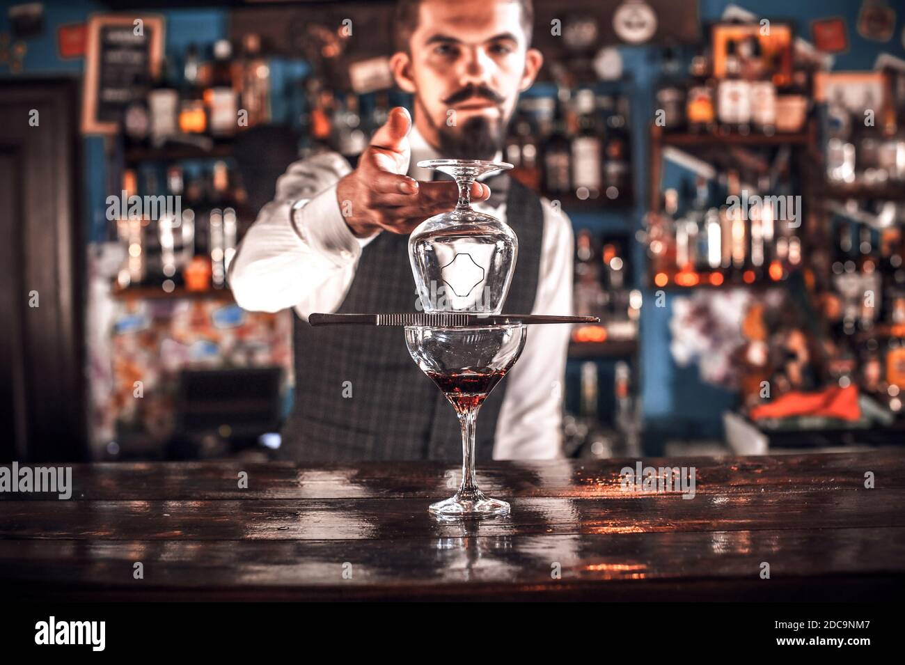 Confident bartending demonstrates the process of making a cocktail ...