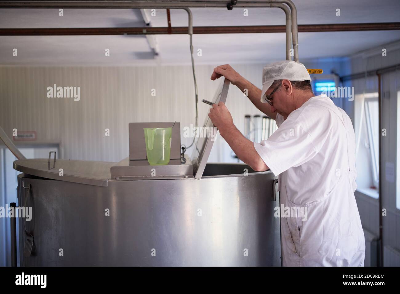Cheese production cheesemaker working in factory Stock Photo - Alamy