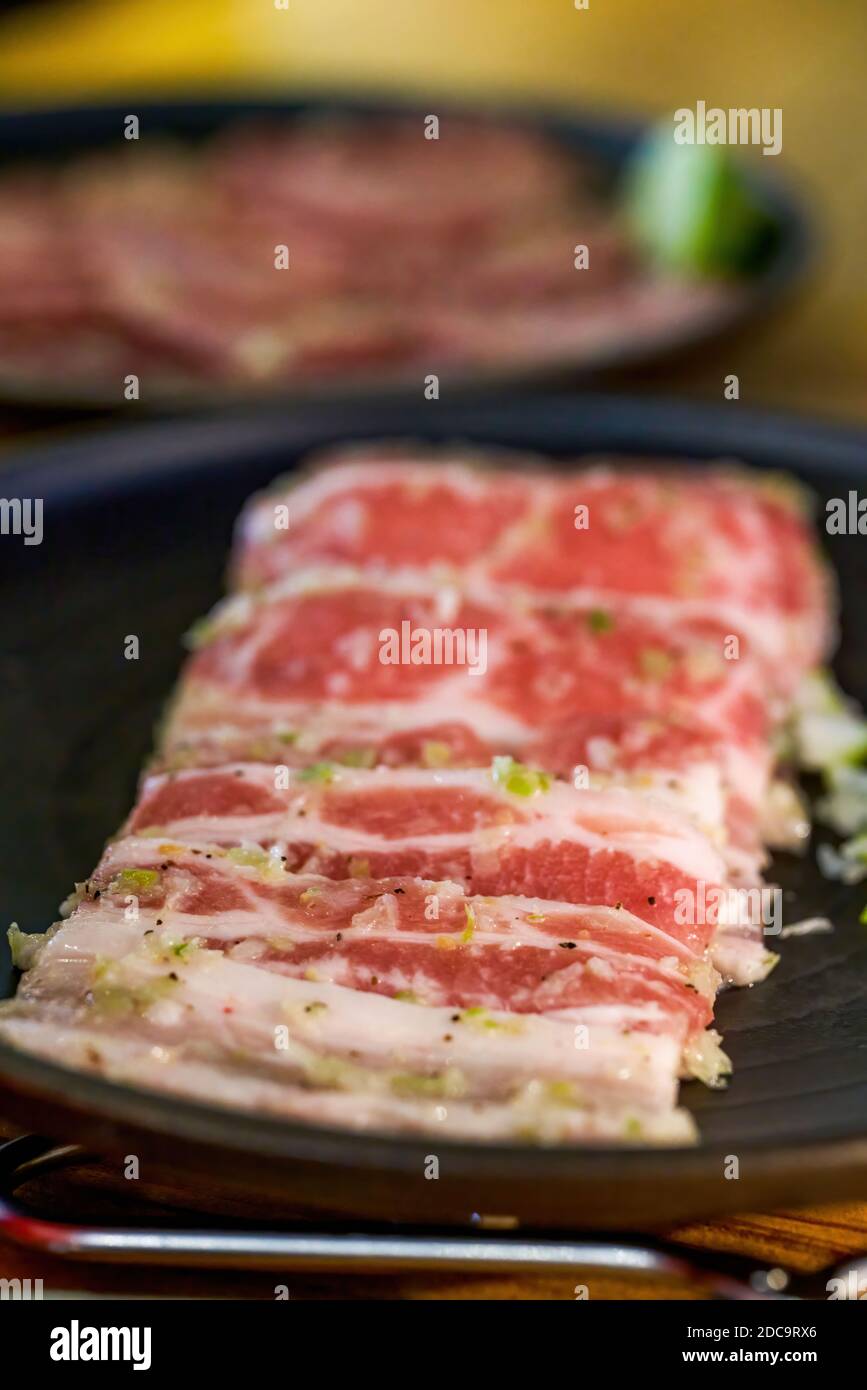Close-up of a dish of thin-cut beef uncooked meat Stock Photo - Alamy