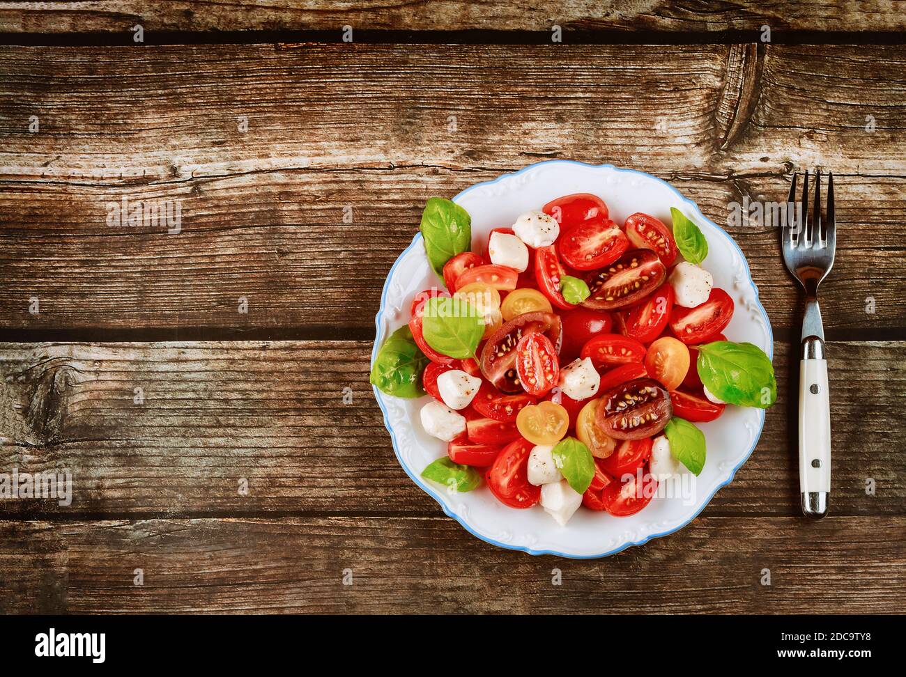 Tasty salad made from cherry tomato, mozzarella cheese and basil on ...
