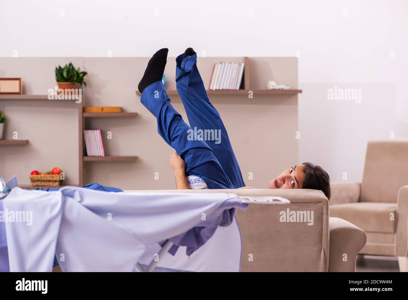 Young employee getting up late at home Stock Photo - Alamy