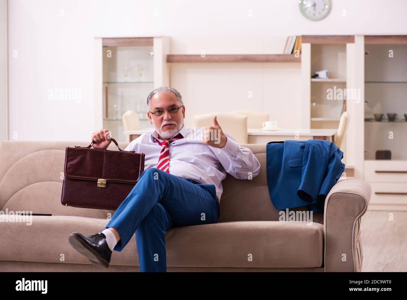 Senior male boss employee coming home from work Stock Photo - Alamy