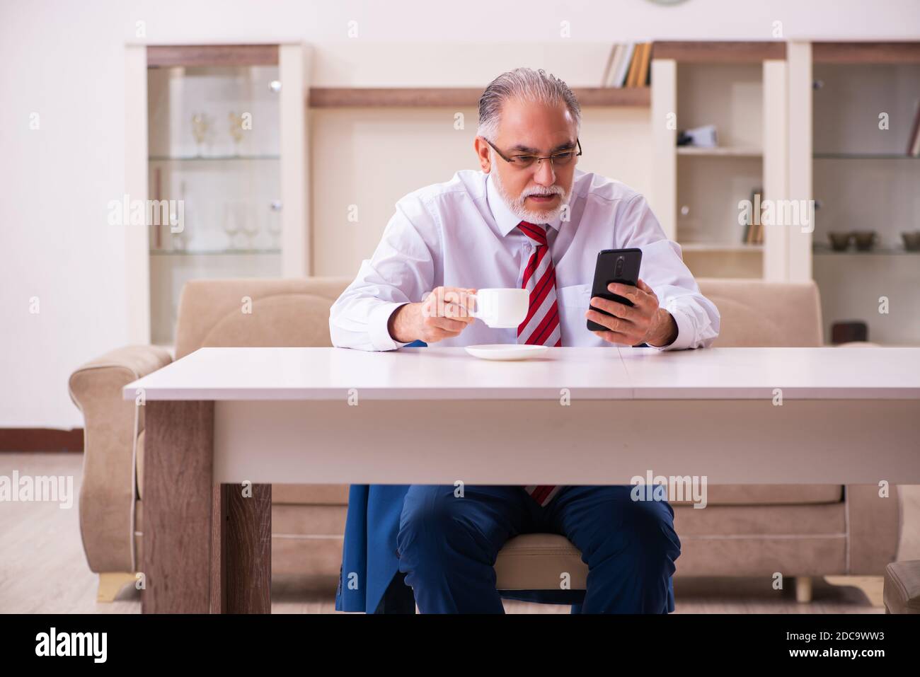 Male boss drinking coffee texting hi-res stock photography and images ...