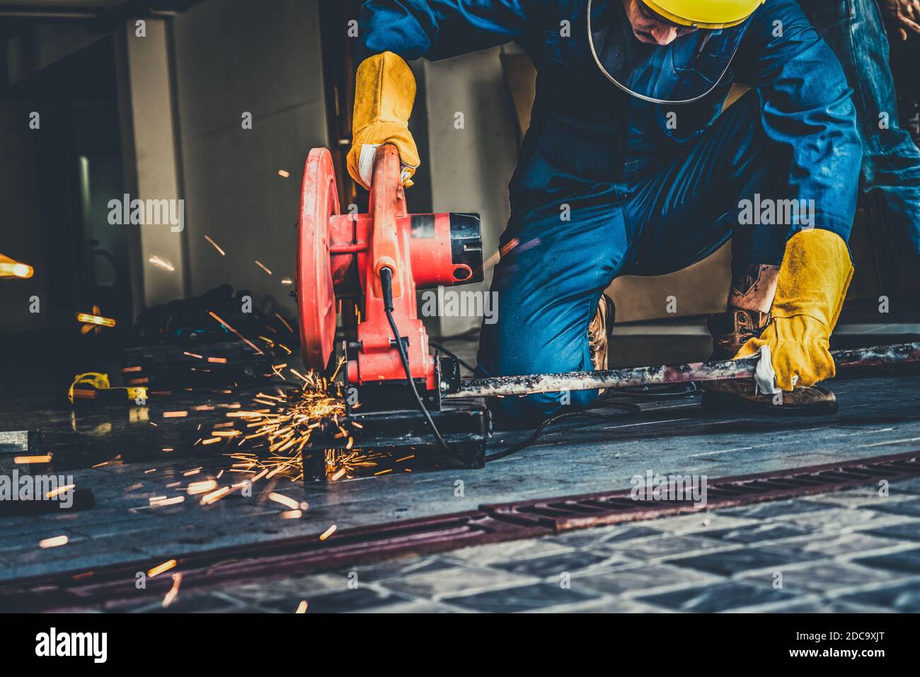 Professional mechanic is cutting steel metal with rotating diamond ...