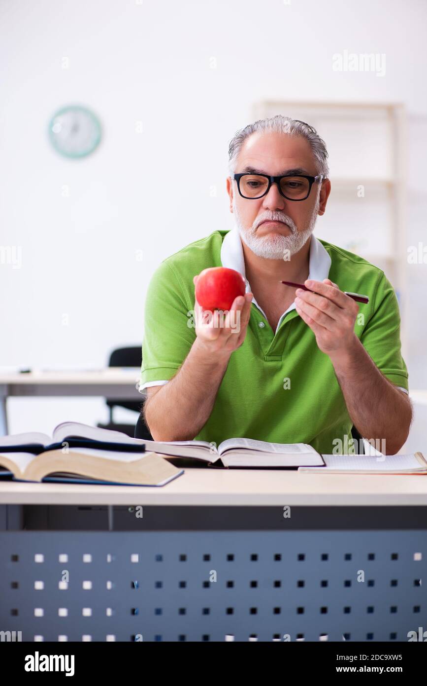 Male teacher eating apple hi-res stock photography and images - Alamy