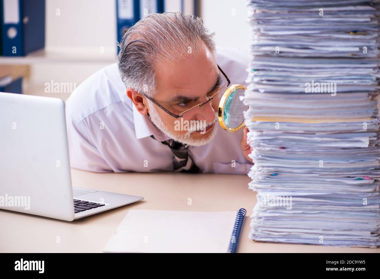 Old employee unhappy with excessive work in the office Stock Photo - Alamy
