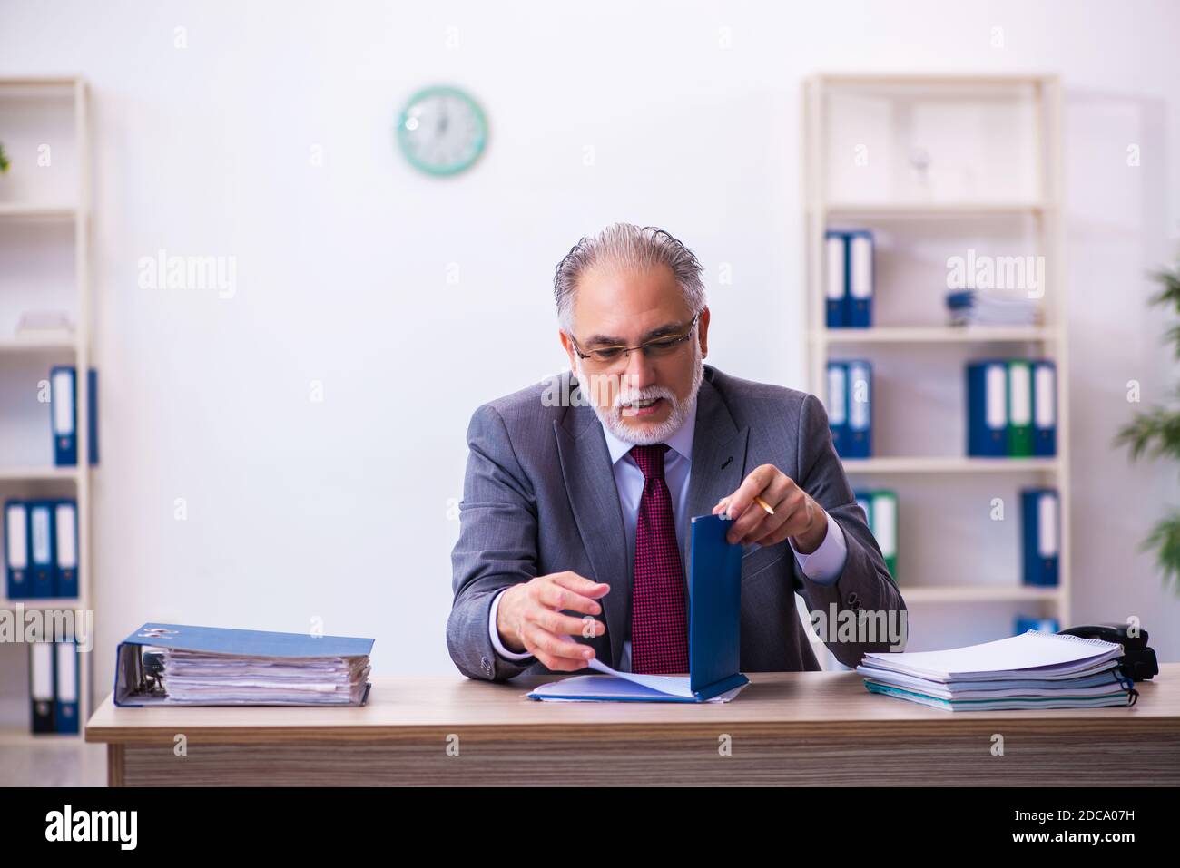 Hardworking employee writing in documents hi-res stock photography and ...