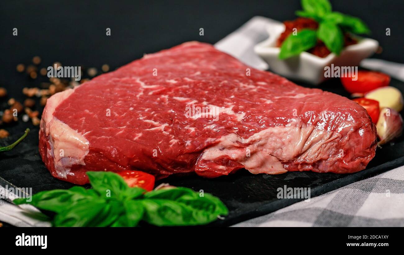 Food banner raw beef steak. Pasture raised meat with spices and herbs ...