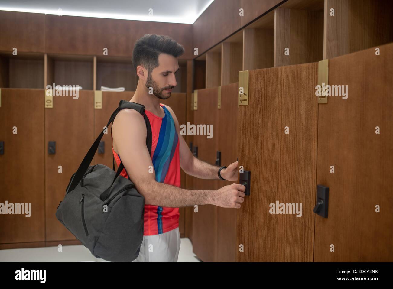 Man changing in locker room hi-res stock photography and images - Alamy