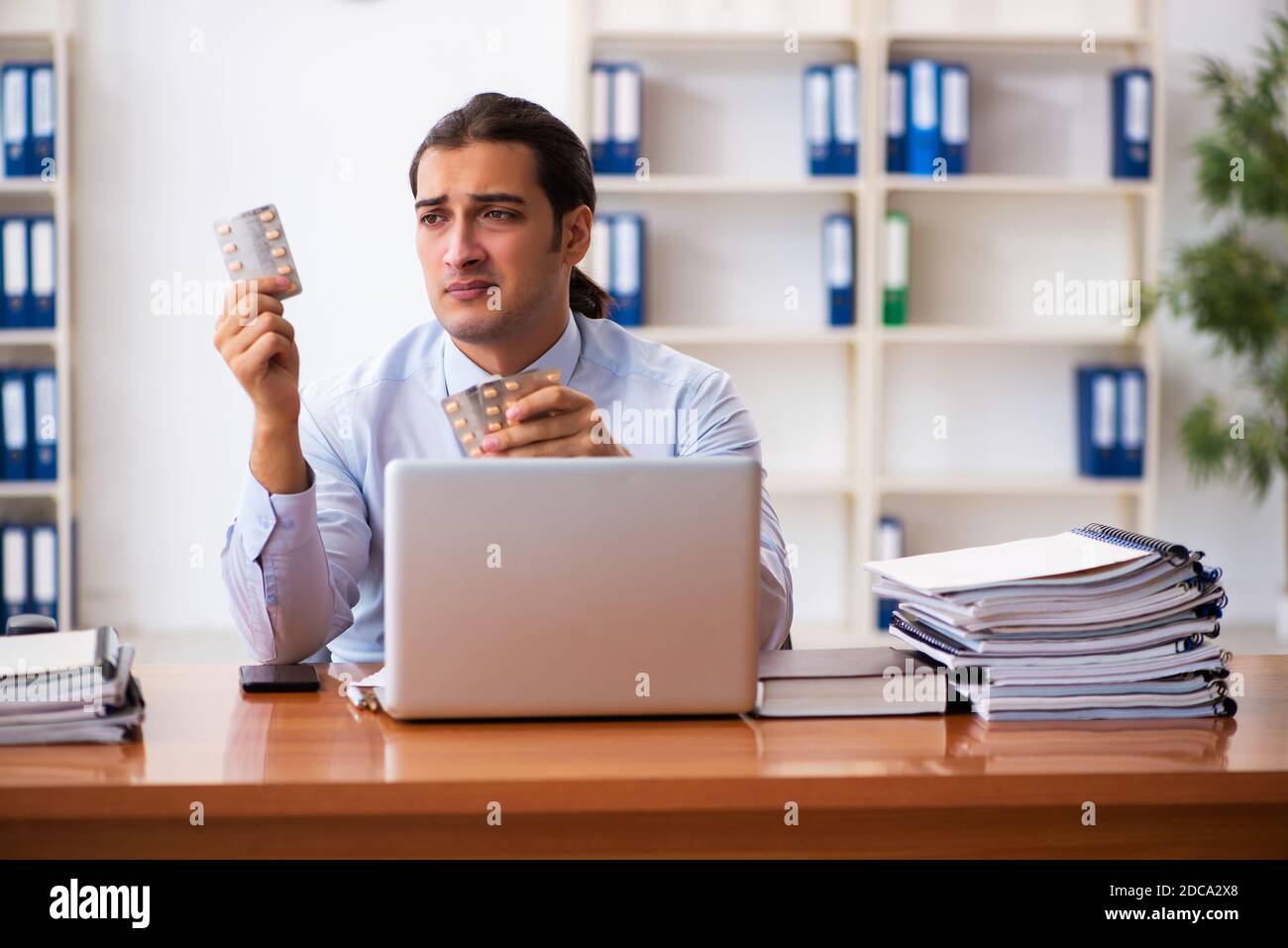 Sick employee working in the office Stock Photo - Alamy