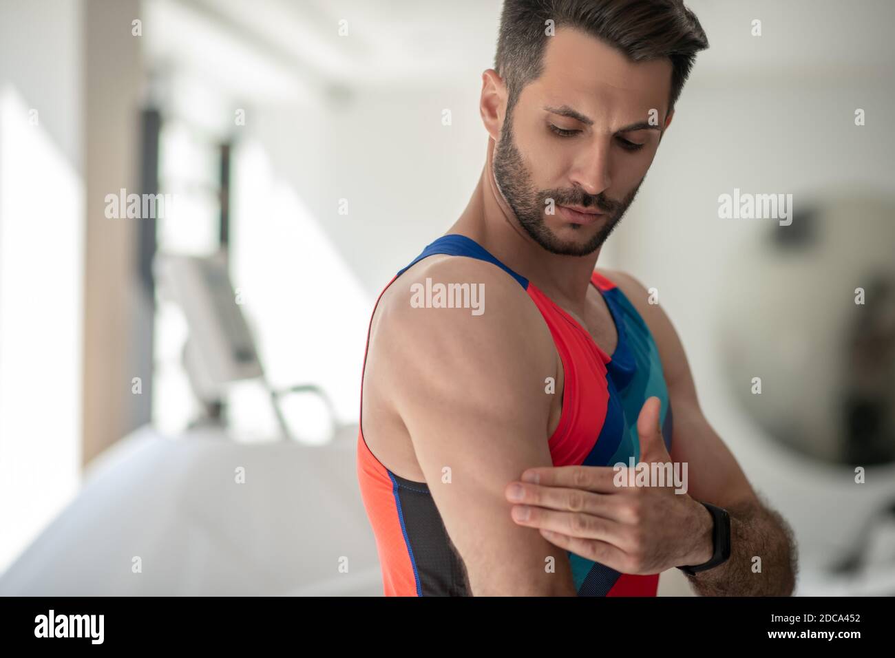 Handsome young man showing biceps hi-res stock photography and images ...