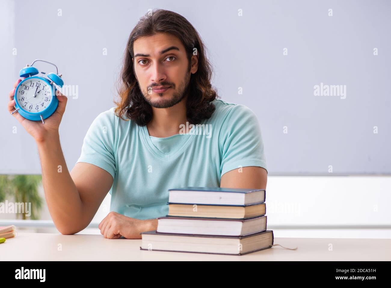 Young student preparing for exams in time management concept Stock ...