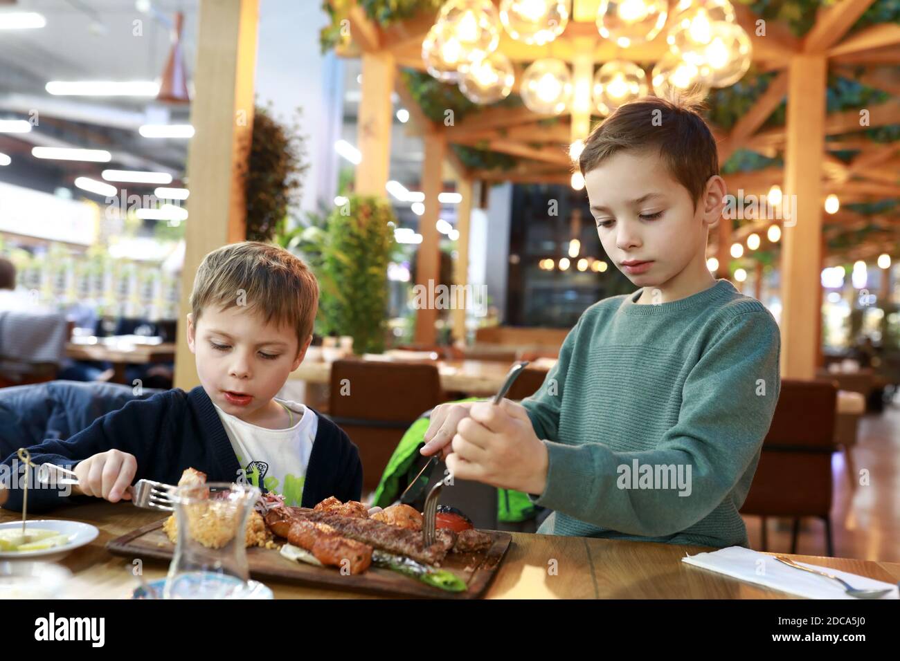 Children eating kebabs in a turkish restaurant Stock Photo - Alamy