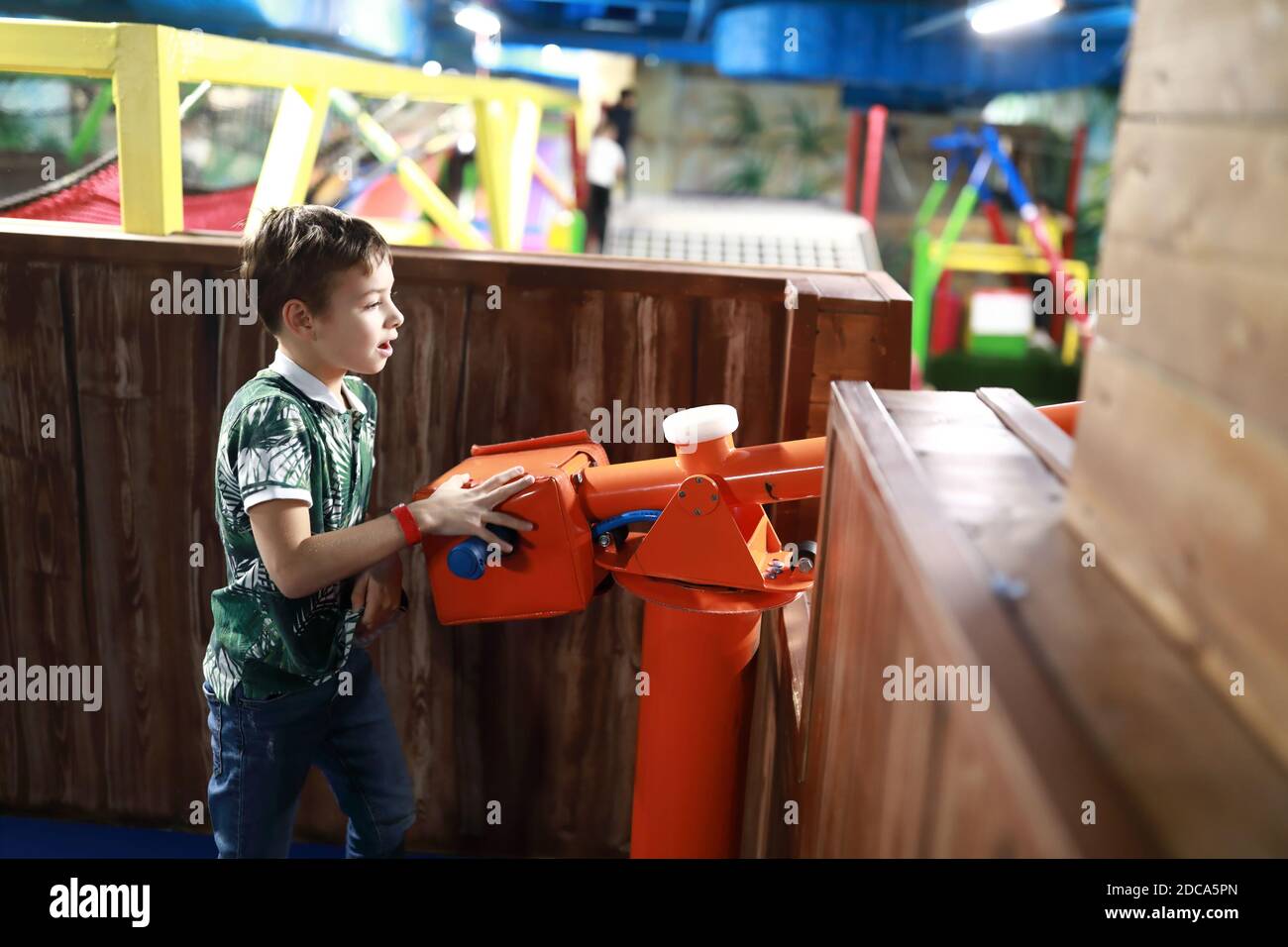 Kid shooting from air gun on playground Stock Photo - Alamy