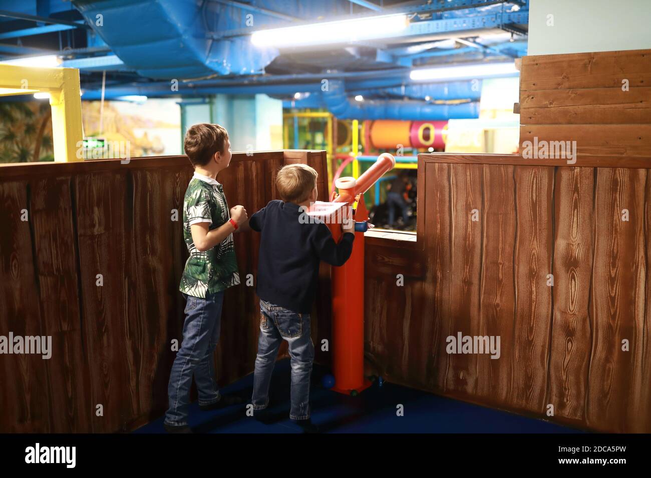Brothers shooting from air gun on playground Stock Photo - Alamy