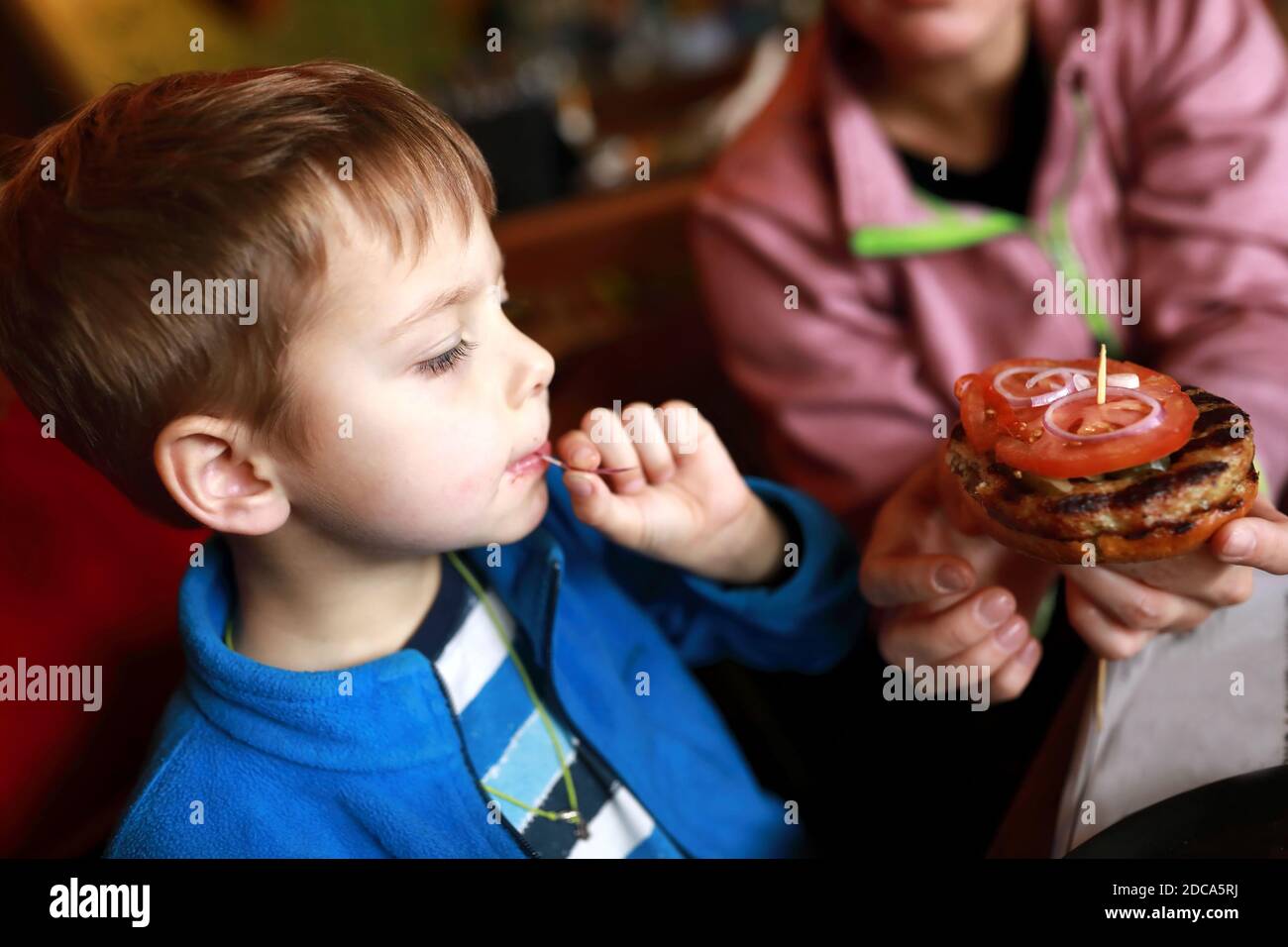 Mom feeding son burger hi-res stock photography and images - Alamy