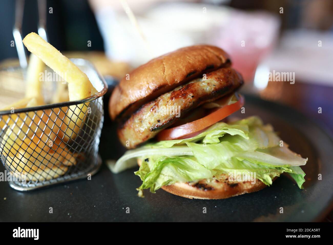Chicken cutlet burger with french fry in restaurant Stock Photo - Alamy