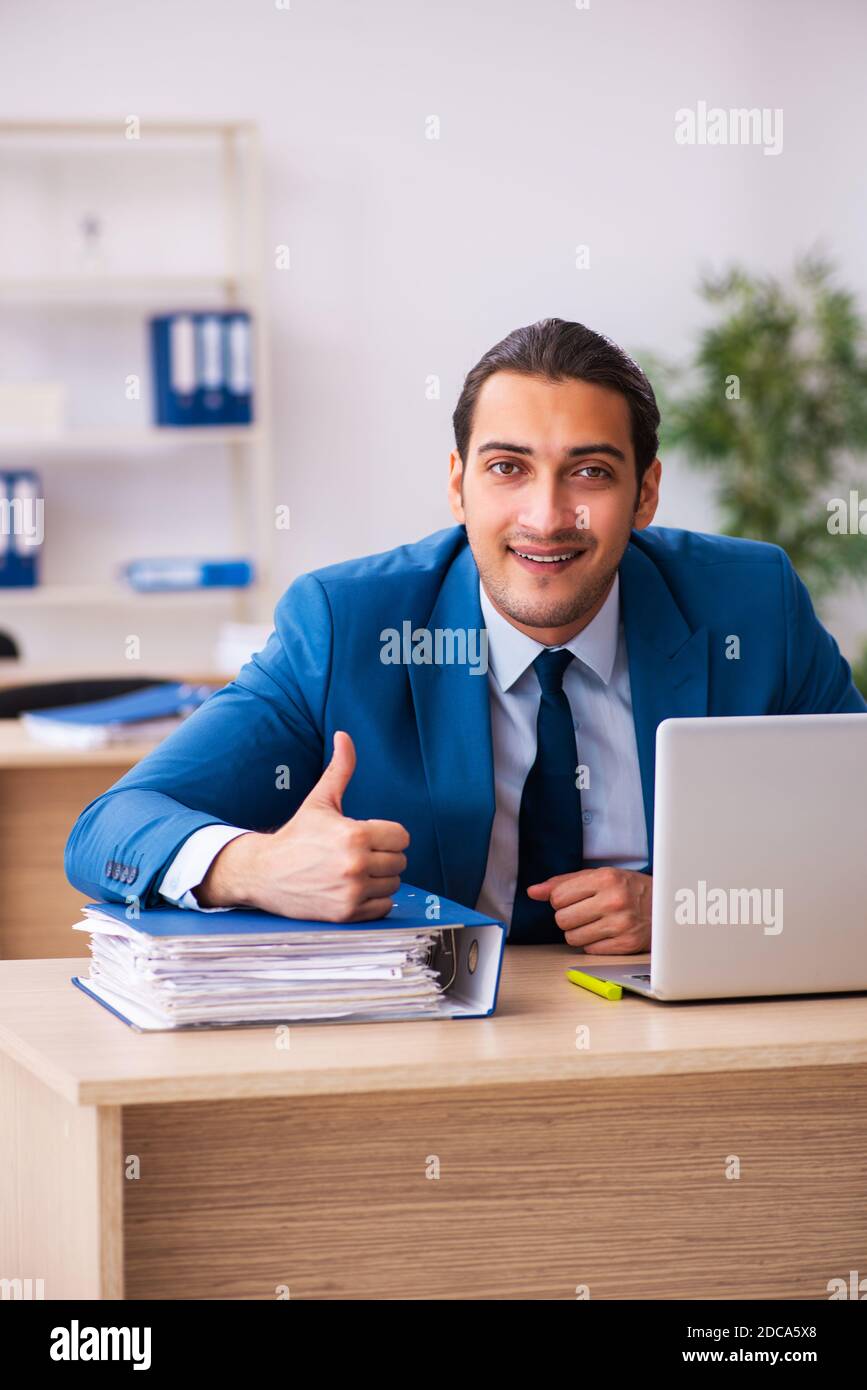 Young employee and too many work in the office Stock Photo - Alamy