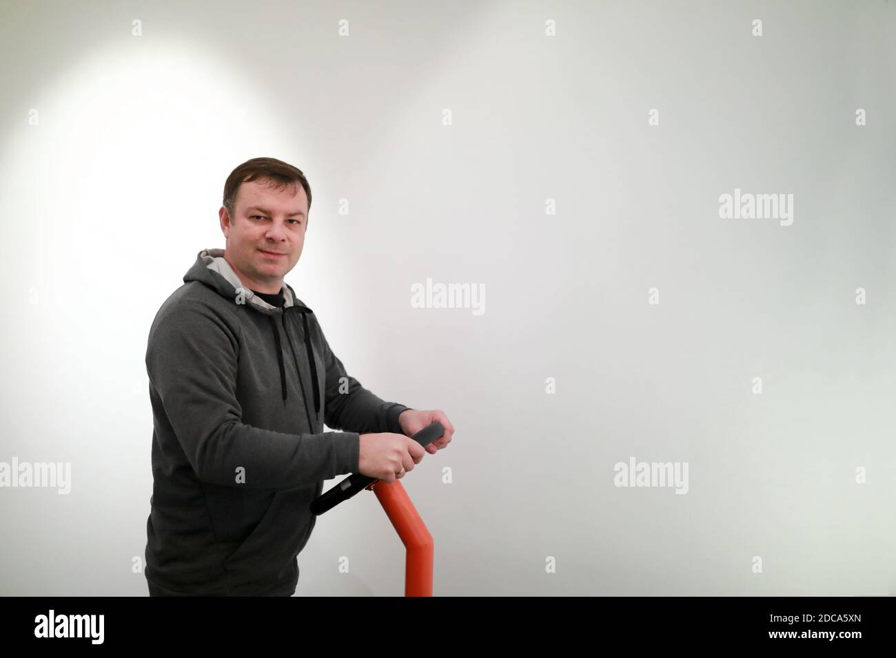 Man driving car simulator on wall background Stock Photo - Alamy