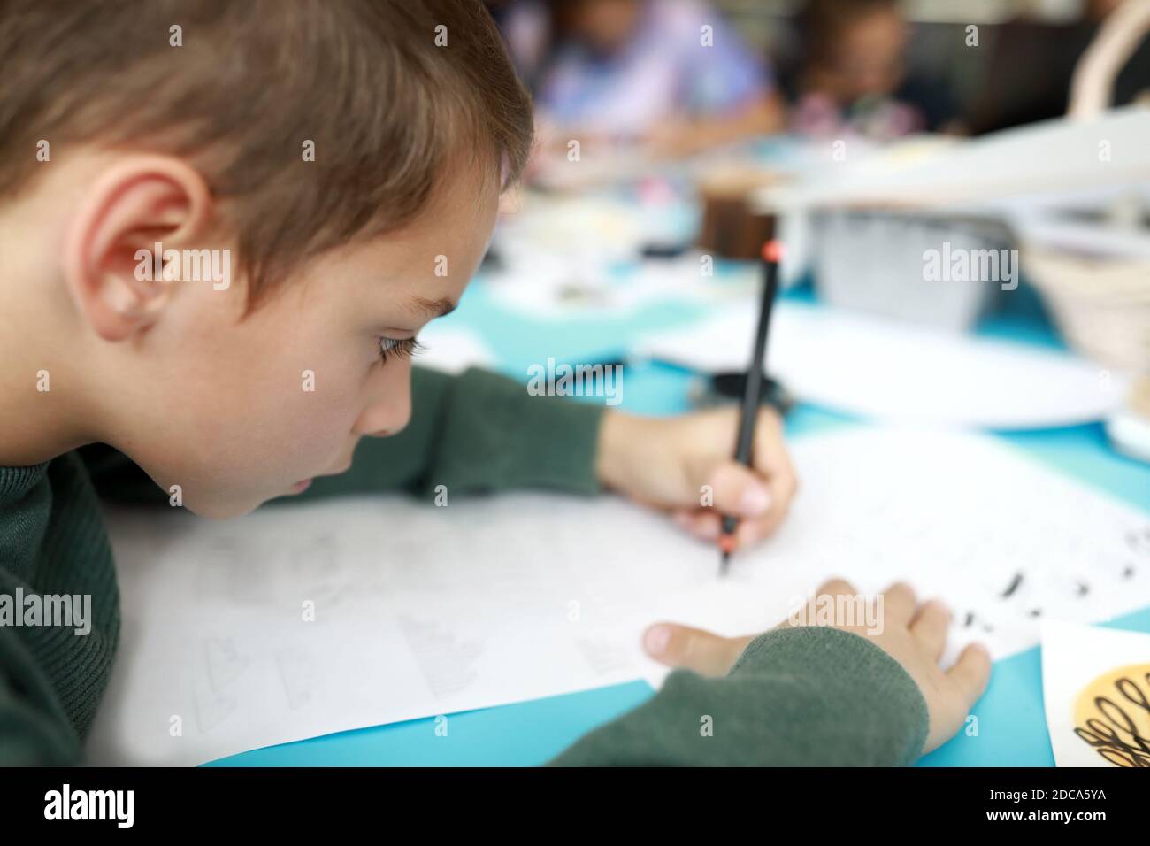 Boy learning calligraphy hi-res stock photography and images - Alamy