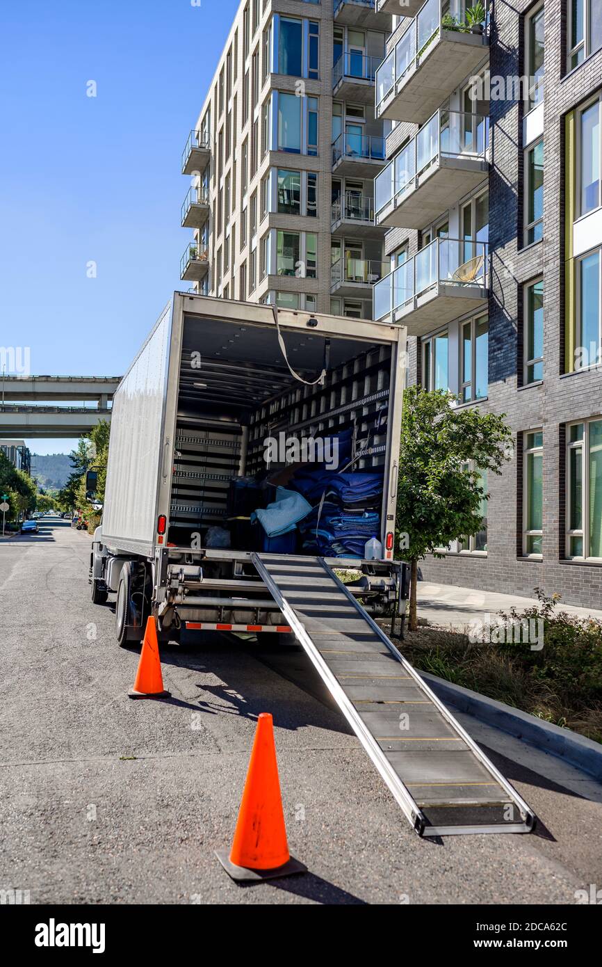 Big rig bonnet industrial semi truck with open box trailer stands on ...