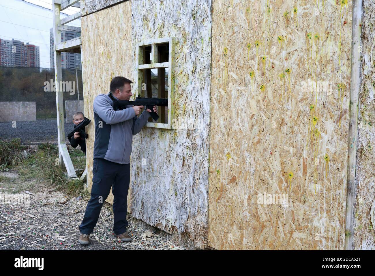 People playing laser tag in outdoor area Stock Photo - Alamy