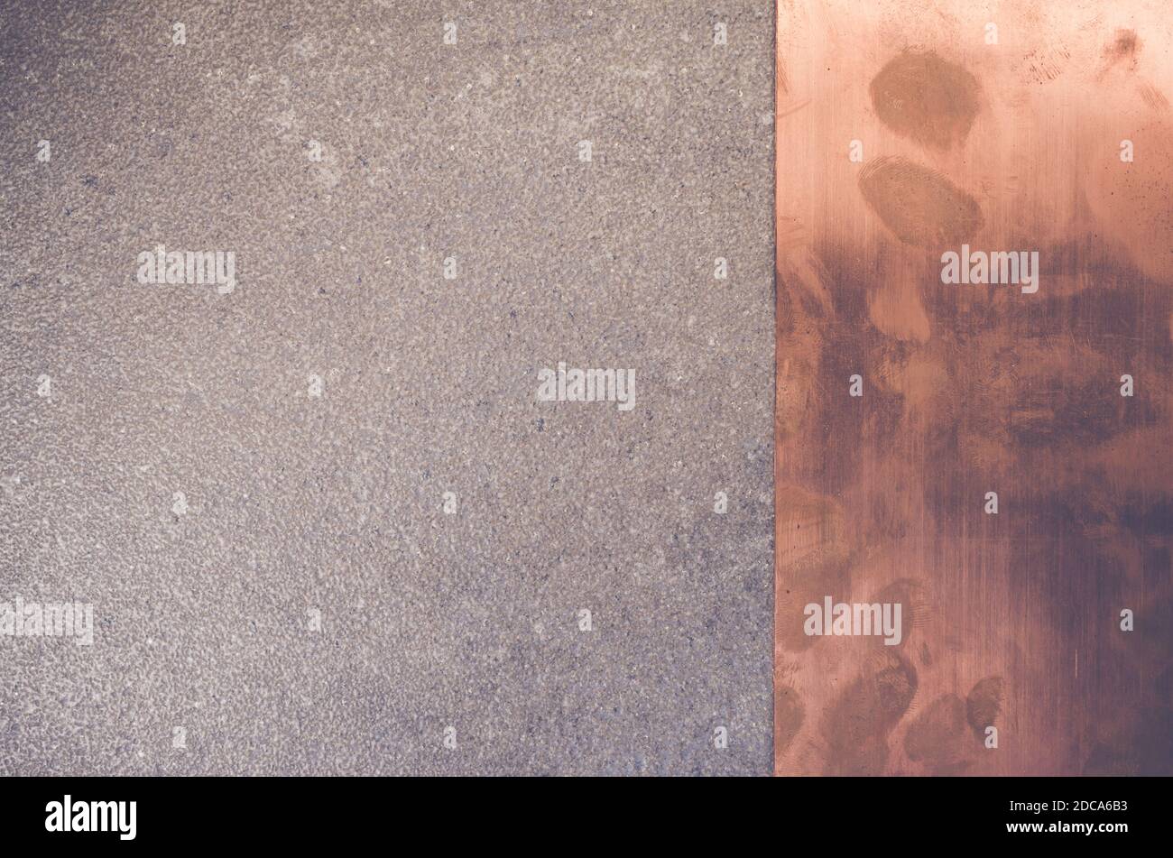 A top view of copper steel plate on a rough-textured surface with copy ...