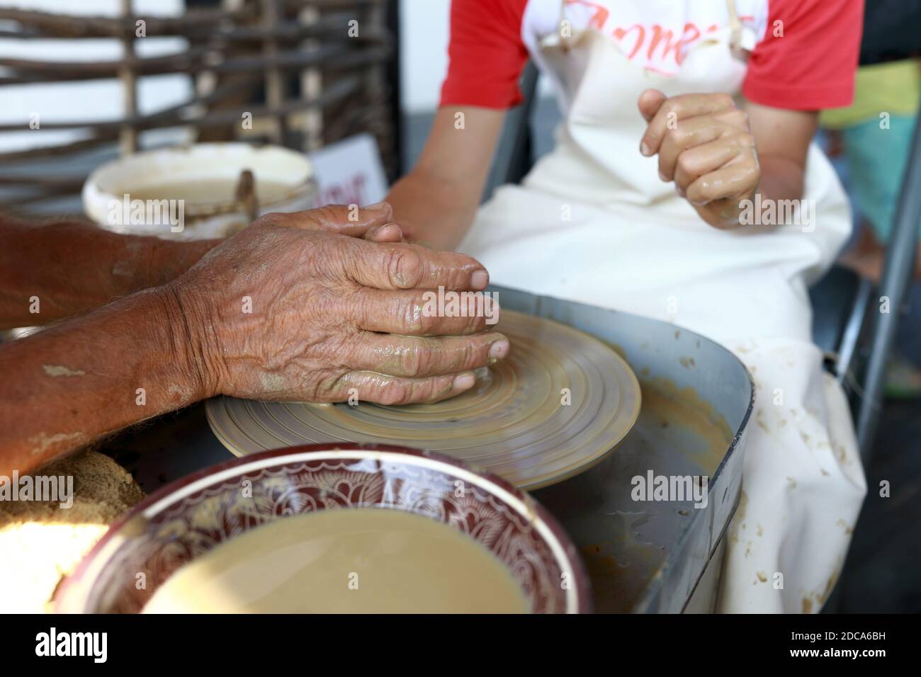 Potter teaches boy pottery in the workshop Stock Photo - Alamy