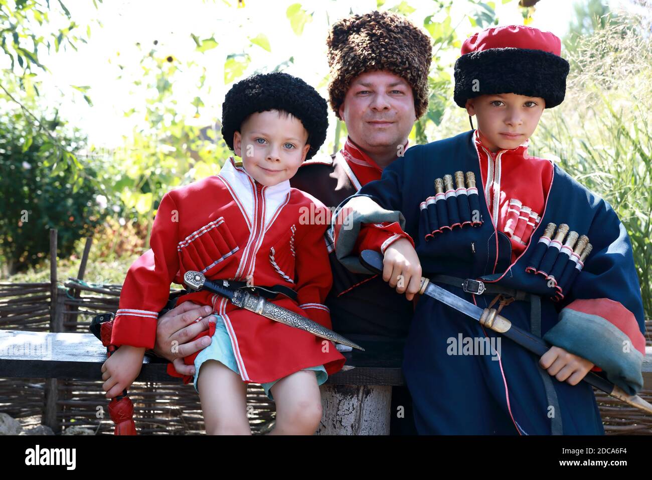 Father with sons in Cossack costumes in backyard Stock Photo - Alamy
