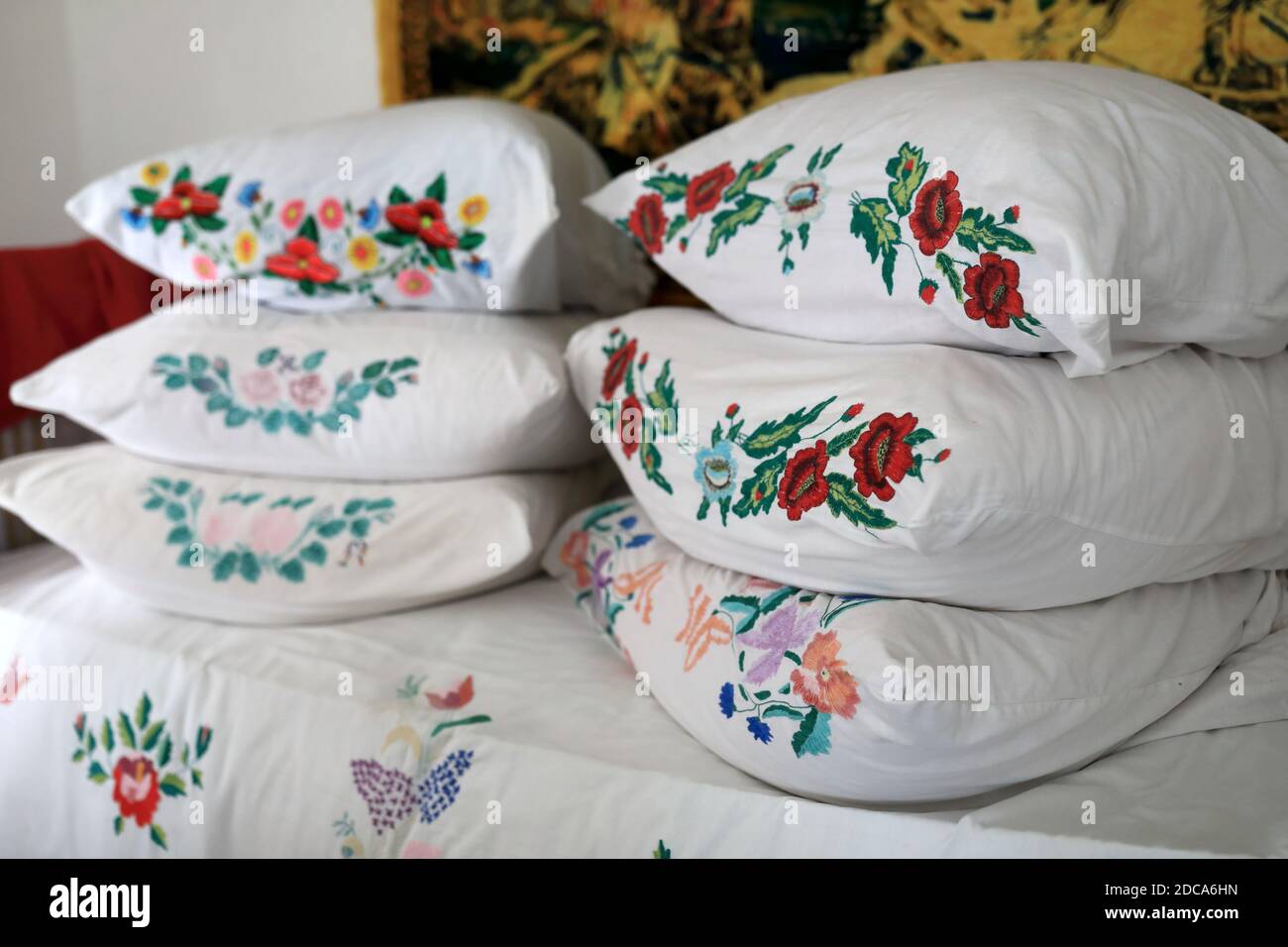 Pillows with embroidered pillowcases on the bed Stock Photo - Alamy
