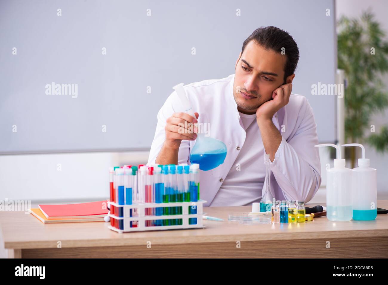 Young chemistry teacher in the classroom Stock Photo - Alamy