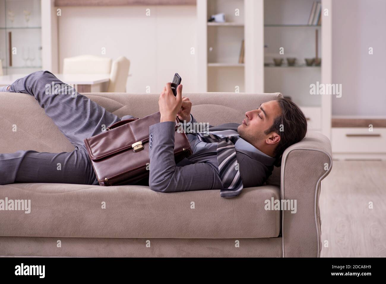 Businessman coming home tired hi-res stock photography and images - Alamy