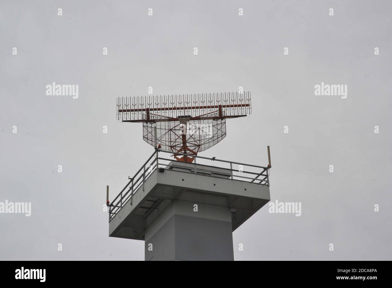 an air traffic control tower with radar, grey sky background Stock ...