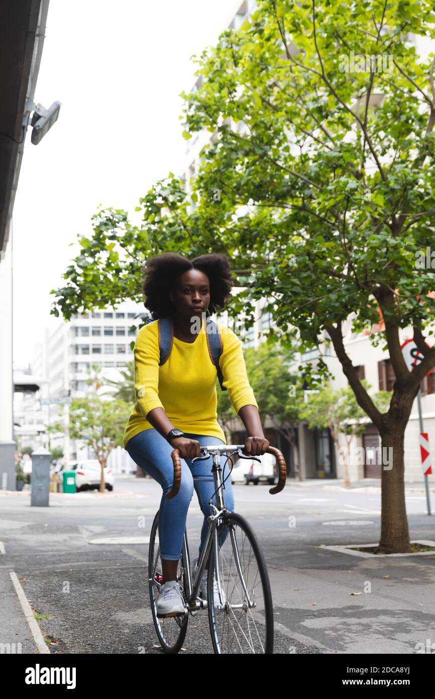 African american woman riding on bicycle on a street Stock Photo - Alamy